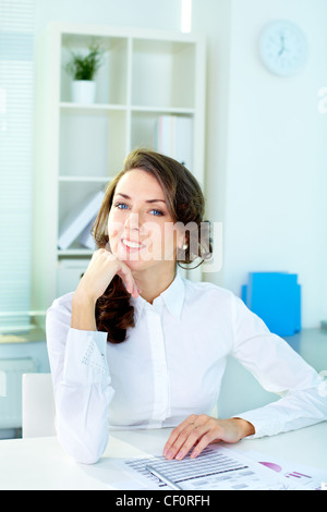 Beautiful positive lady looking at the documents and smiling Stock ...