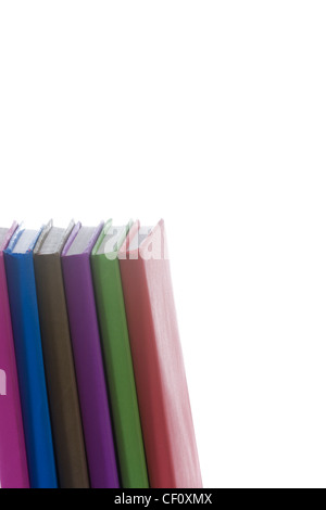 stack of colored books on white desk closeup Stock Photo - Alamy