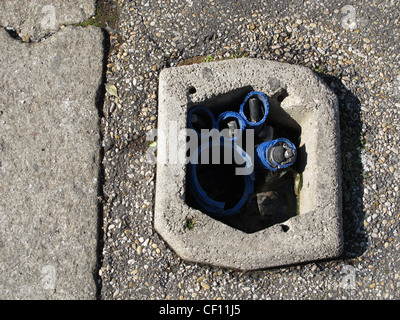 cut power lines on pavement in street Stock Photo - Alamy