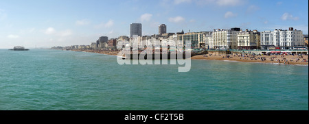 A busy Brighton beach with the West Pier in background on a hot July ...