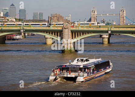 Thames Clippers boat heading east towards the City of London, Southwark ...