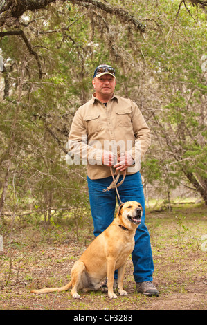 A middle aged man walking his dog at Plumpton Racecourse Stock Photo ...