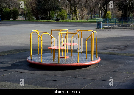 Children's play area roundabout merry-go-round. Old worn weathered ...
