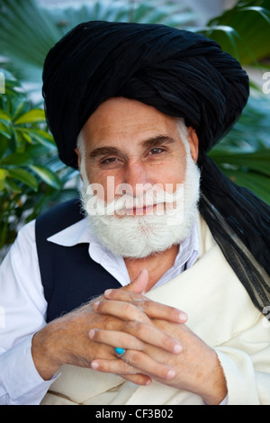 Muslim man with a beard wearing a white cap isolated over white ...