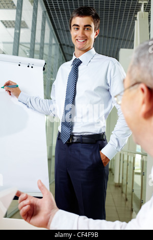 Young manager presenting new plan illustrated by colourful chalk drawn ...
