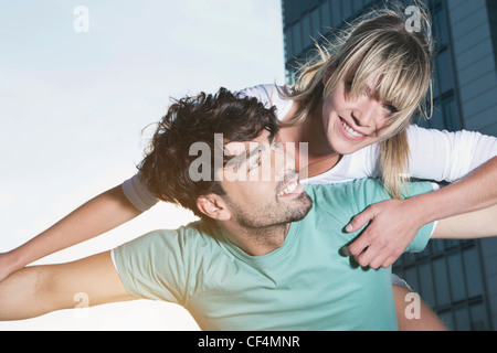 Germany, Cologne, Young couple flying, smiling, portrait Stock Photo ...