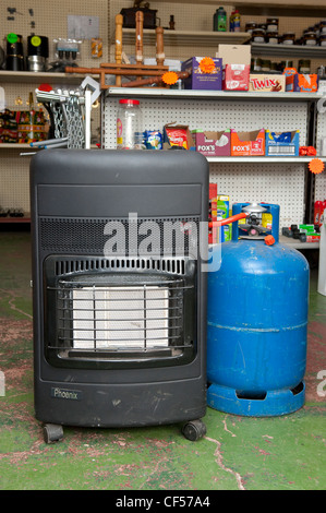 Mobile heater being fuelled by butane gas ,with one section giving out ...