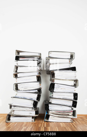 Piled of office files on parquet floor Stock Photo - Alamy