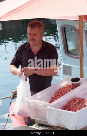 Fisherman selling fish direct from his boat, Argostoli, Kefalonia ...