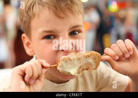 Child eating meat on a skewer. Barbecue meat Stock Photo - Alamy