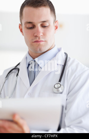 Young hospital doctor checking notes Stock Photo - Alamy
