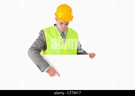 Male builder pointing finger at something at construction site Stock ...