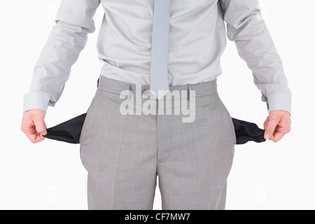 Poor businessman showing empty pants pockets isolated on white ...