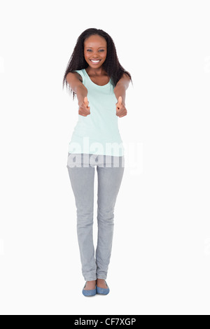 Woman giving thumbs up on blue background Stock Photo - Alamy