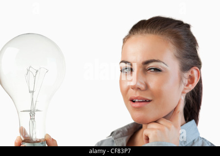 Businesswoman looking at huge light bulb in her hand Stock Photo - Alamy