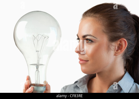 Businesswoman looking at huge light bulb in her hand Stock Photo - Alamy