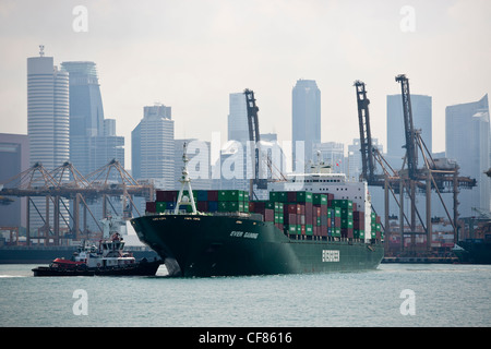 A container ship is maneuvered into position at the Brani terminal of ...