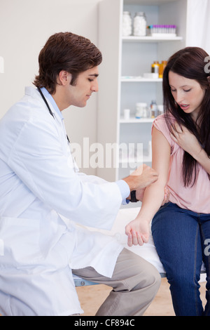 young doctor prepares an injection for a young patient Stock Photo - Alamy