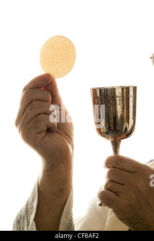 A Catholic priest with cup and host with communion, Ein katholischer ...