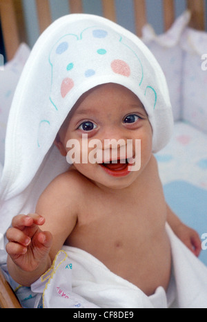 A Happy baby boy standing in grass on the field of daisy Stock Photo ...