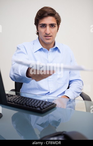 Businessman handing over paperwork Stock Photo - Alamy