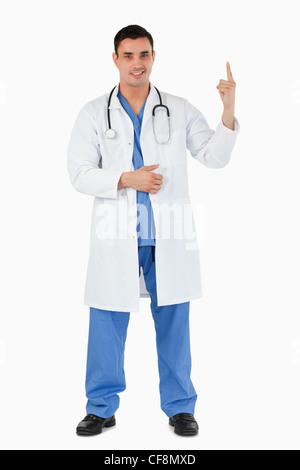 Happy doctor pointing at copy space Stock Photo - Alamy