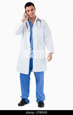Concentrated male doctor making a call Stock Photo - Alamy