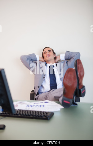 businessman man putting his feet up while answering telephone in office ...