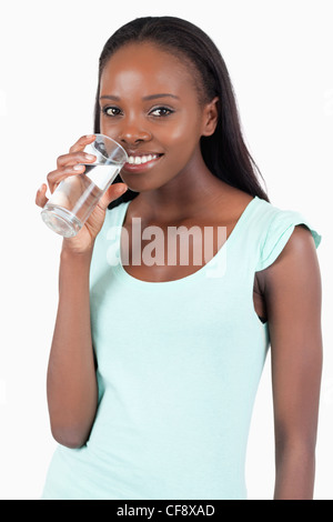 Happy smiling young woman with crystal deodorant and feather on blue ...