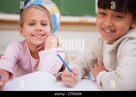 Cute schoolgirls doing classwork Stock Photo - Alamy