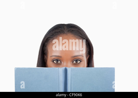 Young woman behind books, isolated on white background Stock Photo - Alamy