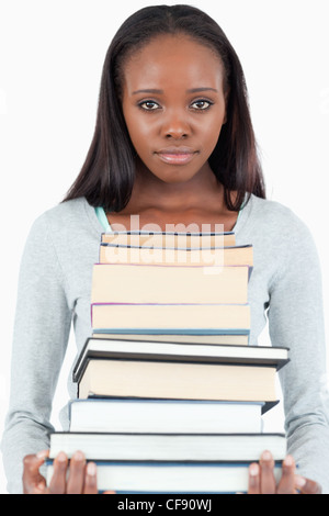 Sad woman with pile of books looking to the side Stock Photo - Alamy