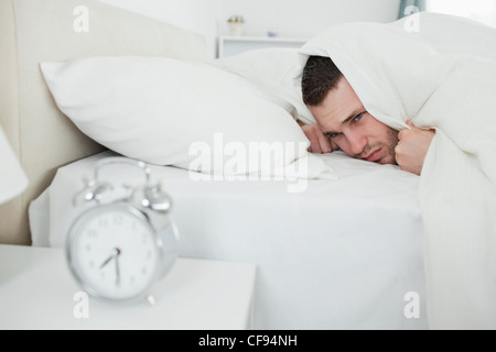 Man being awakened by an alarm clock Stock Photo - Alamy