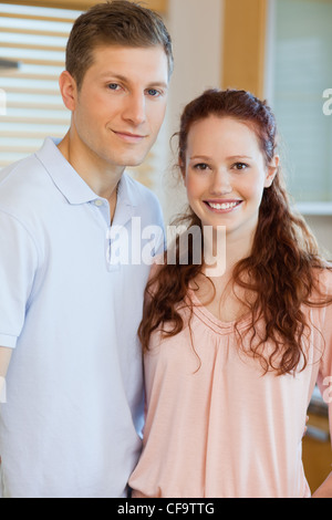 Cheerful couple standing inside house under construction Stock Photo ...