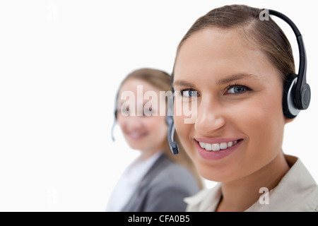 Young female operators using headsets against a white background Stock ...