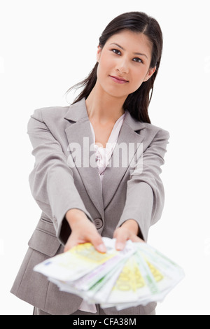 Businesswoman offering money Stock Photo - Alamy