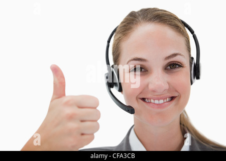 Smiling call center agent giving thumb up Stock Photo - Alamy