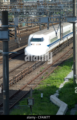 A JR 700 series shinkansen (bullet train) speeds through Shin Yokohama ...