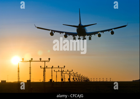 Boing 747 landing at sunset Stock Photo - Alamy