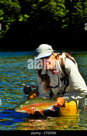 Woman holding rainbow trout, New Zealand Stock Photo - Alamy