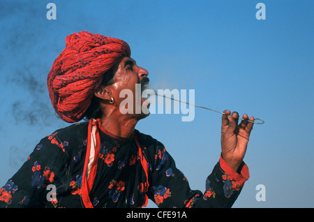 Indian fire-eater with turban Stock Photo - Alamy
