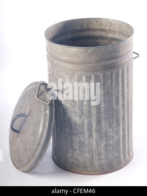 An old corrugated metal garbage bin with folding handles and lid ...