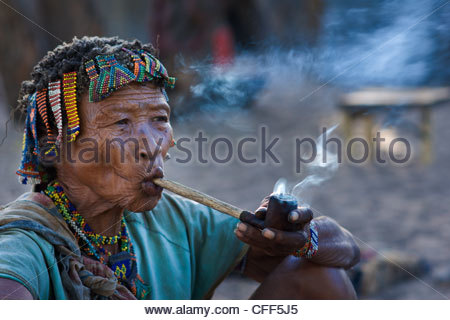 Tribal women smoking traditional pipe on the vegetable market in Ruma ...