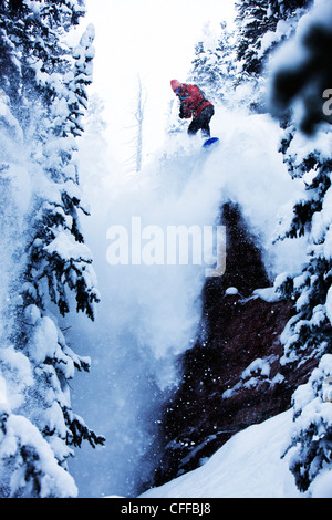 Snowboarder jumping off a cliff in Val Thorens, France Stock Photo - Alamy