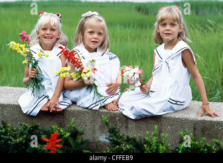 Cute Blonde Identical Girl Triplets intennis gear, USA Stock Photo - Alamy
