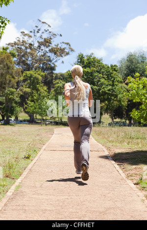 Back view of a fitness woman jogging outdoors Stock Photo - Alamy