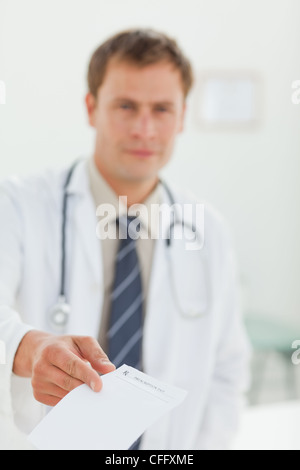 Doctor handing over a prescription Stock Photo - Alamy