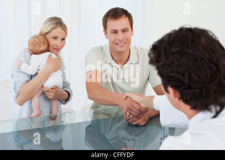 Family with their baby seeing the pediatrician Stock Photo - Alamy