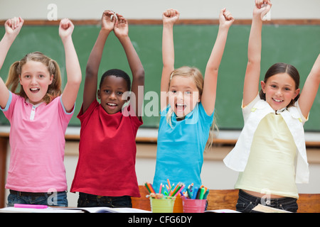 Classmates cheering in classroom Stock Photo - Alamy