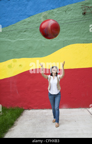Young woman throwing a big ball Stock Photo - Alamy